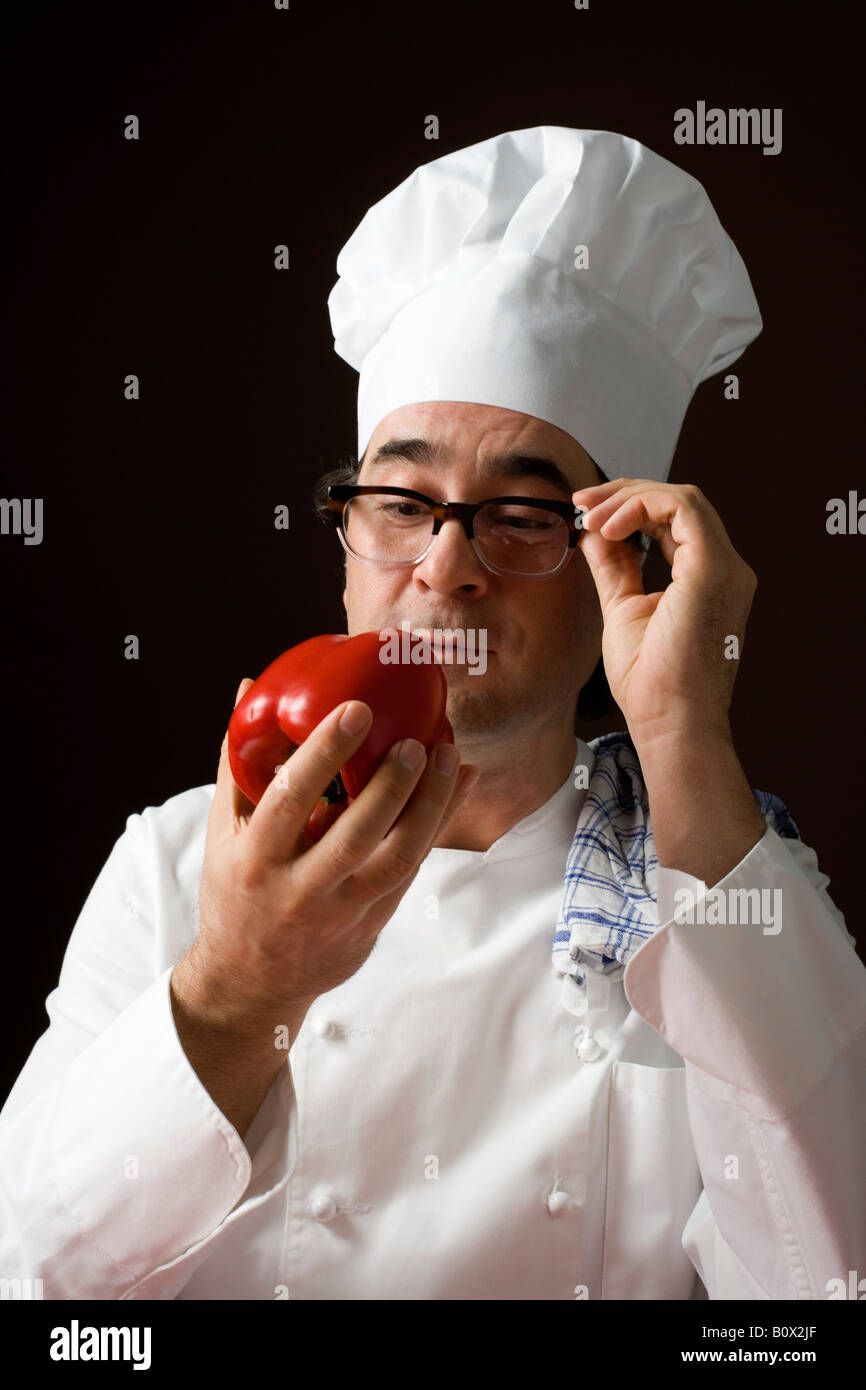 Stereotypical chef staring at a red bell pepper Stock Photo - Alamy