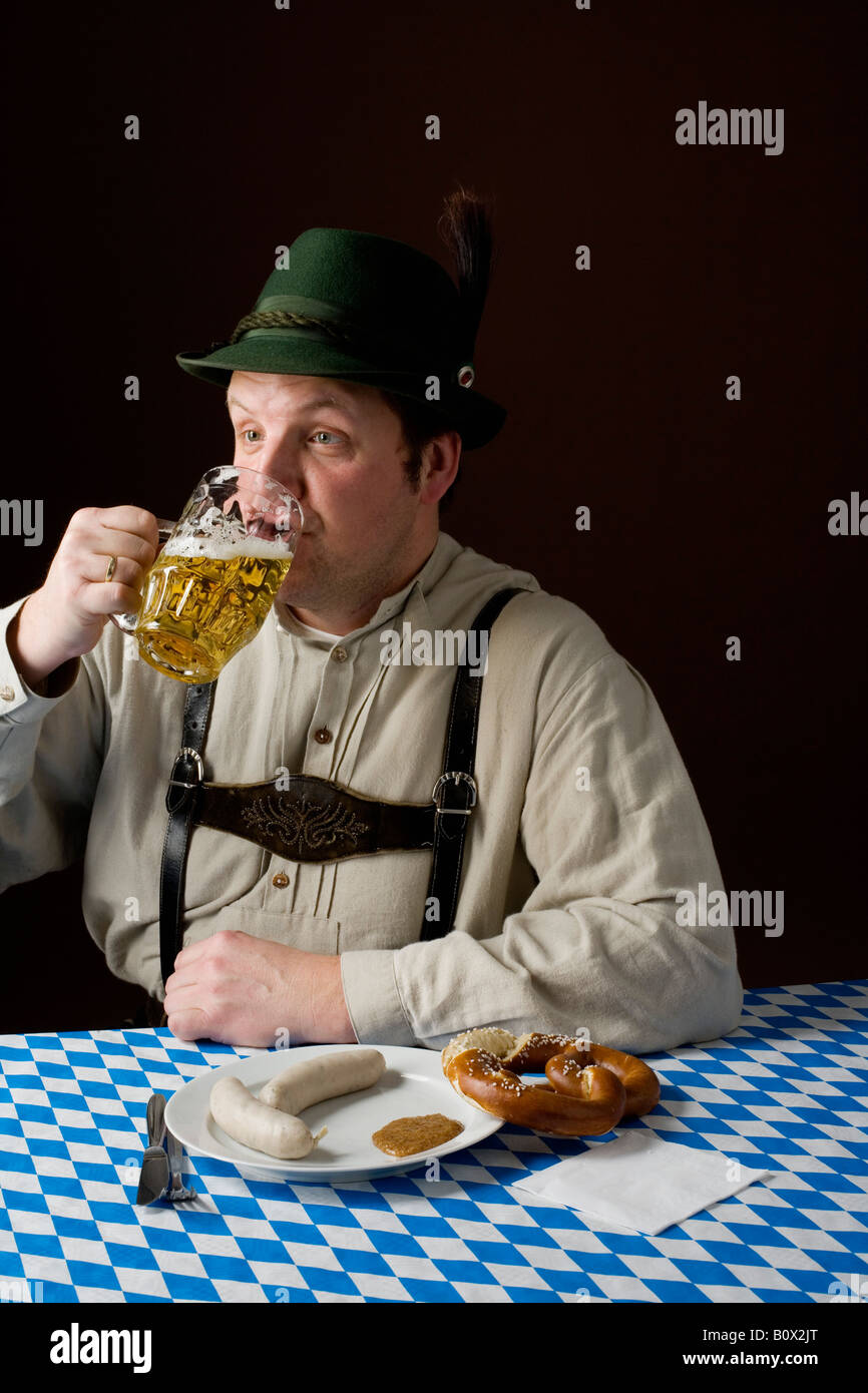 Stereotypical German man in Bavarian costume drinking a beer and German ...