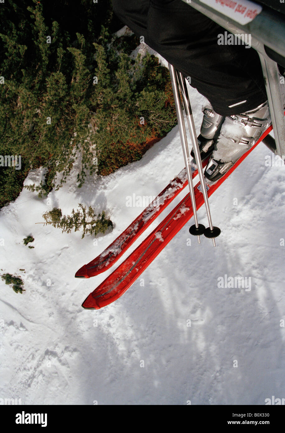 A skier sitting on ski lift Stock Photo - Alamy
