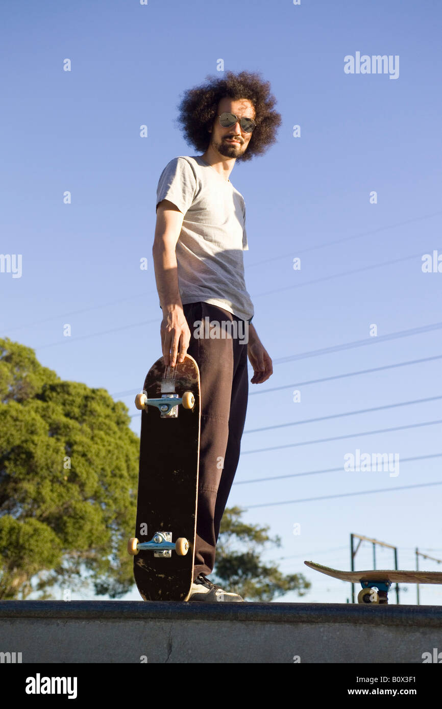 A skateboarder standing at the top of a ramp Stock Photo - Alamy