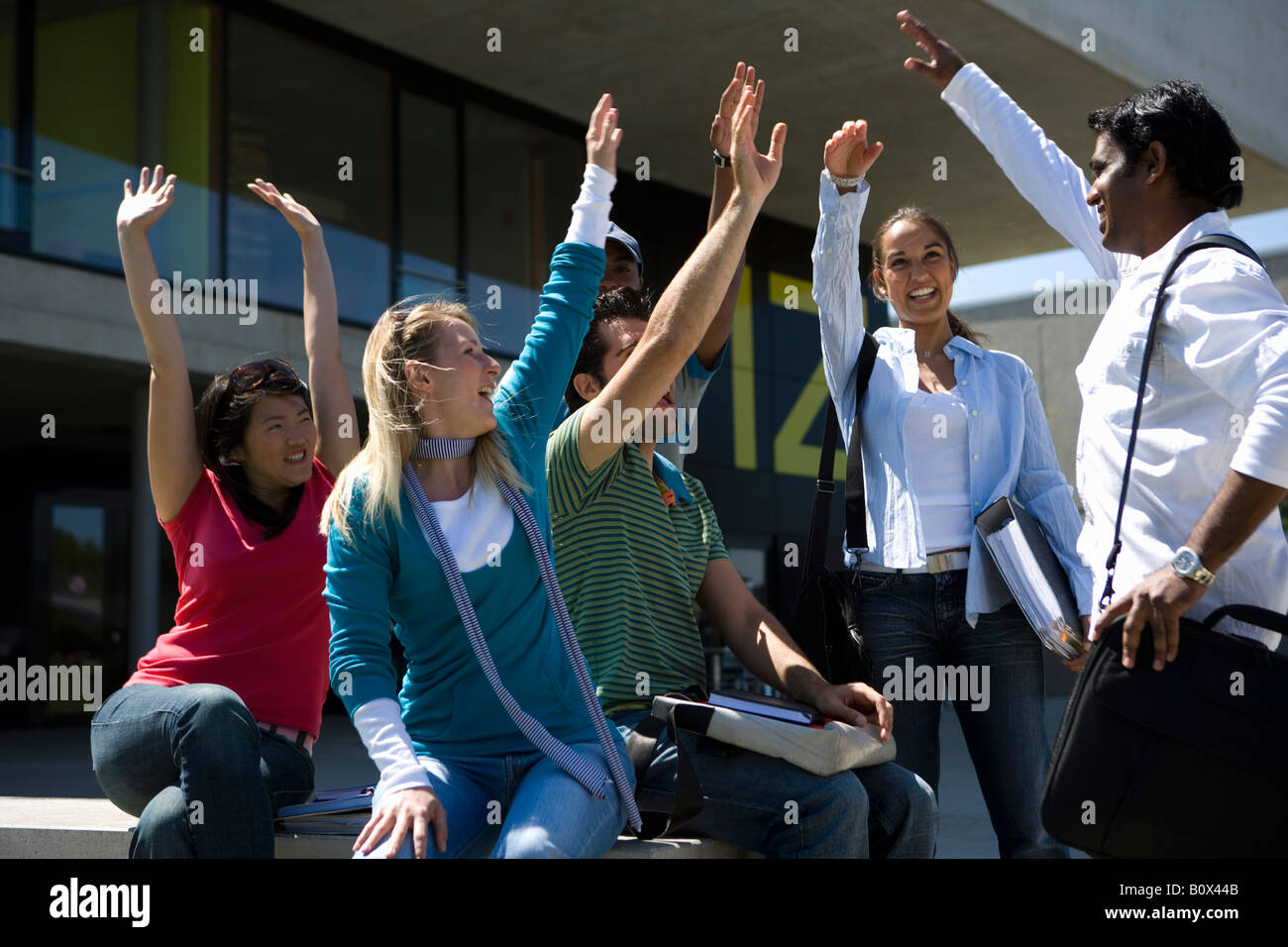 University students raising their hands at a meeting on campus Stock ...