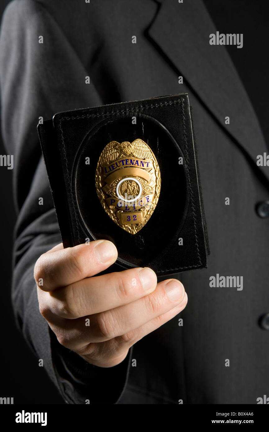 A police officer holding ID Stock Photo - Alamy