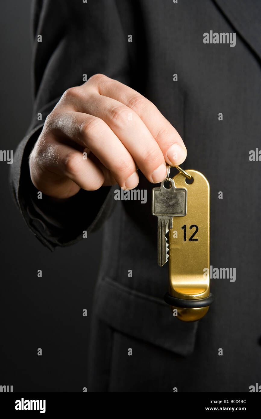 A man holding hotel key Stock Photo - Alamy