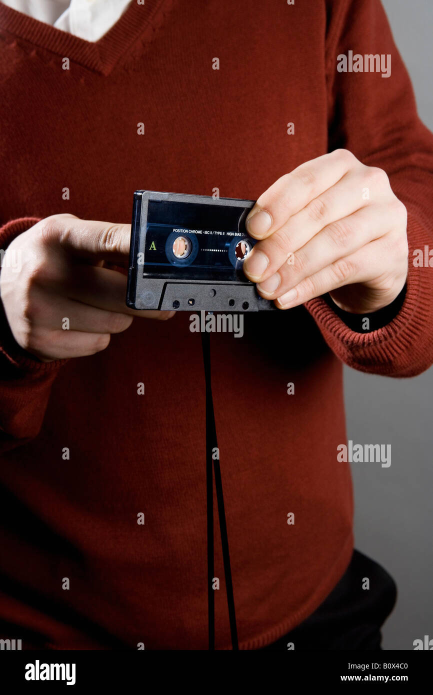 Hand holding audio cassette tape hi-res stock photography and images ...