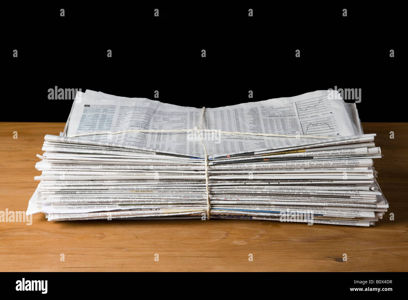A stack of newspapers tied up with string Stock Photo - Alamy