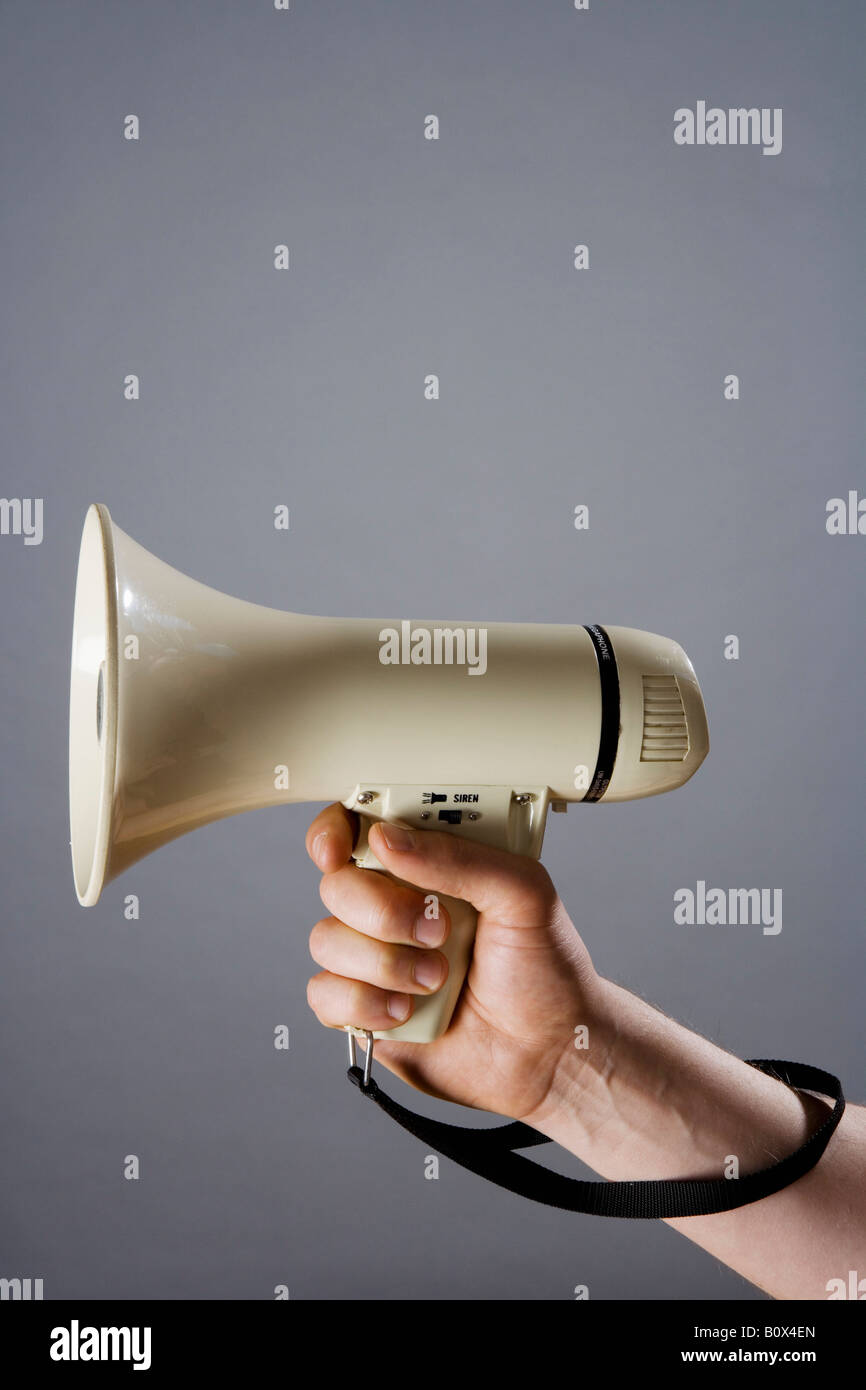 A hand holding a megaphone Stock Photo - Alamy