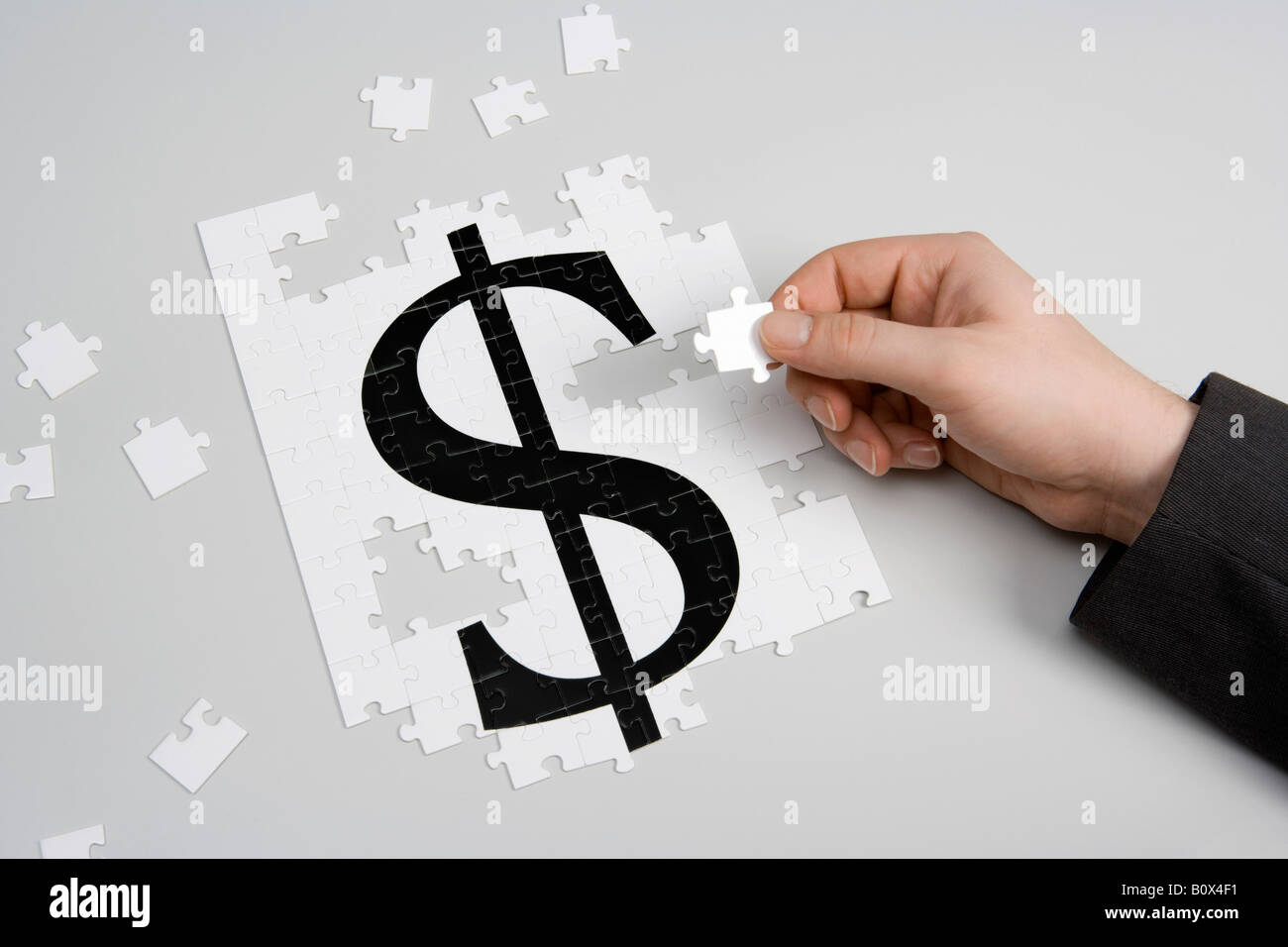 Dollar sign jigsaw puzzle Stock Photo - Alamy