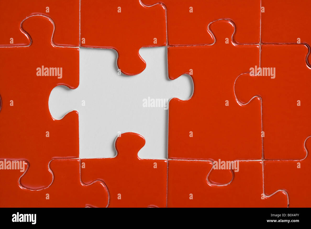 Missing piece in a red jigsaw puzzle Stock Photo - Alamy