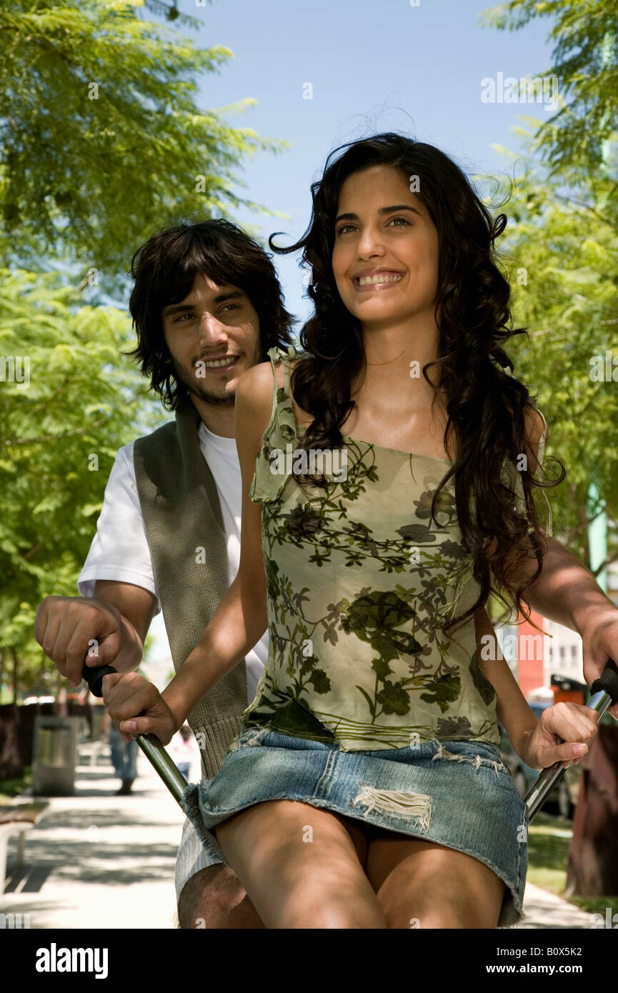 A young couple riding on a bicycle together Stock Photo - Alamy