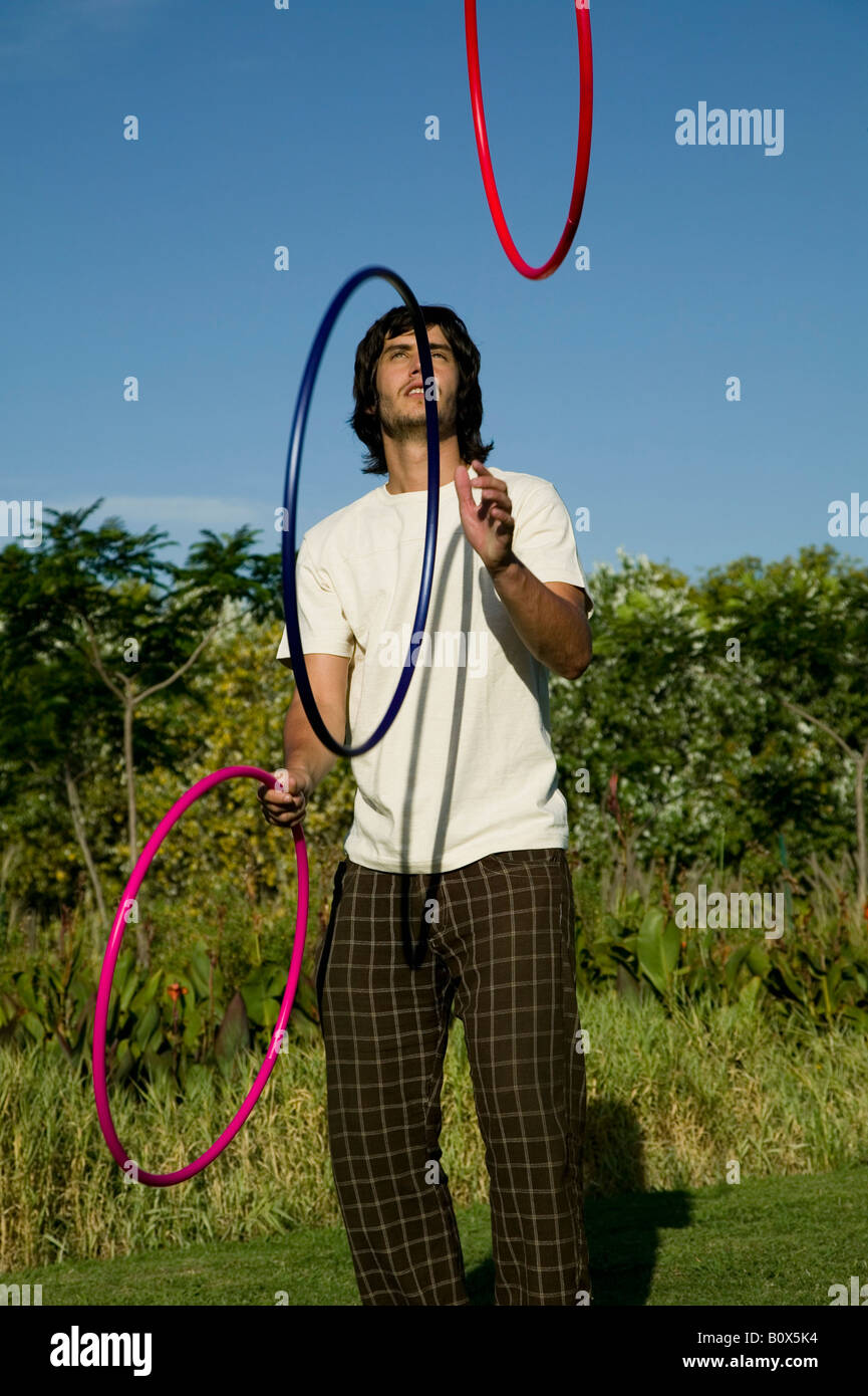 A young man juggling hoops Stock Photo - Alamy