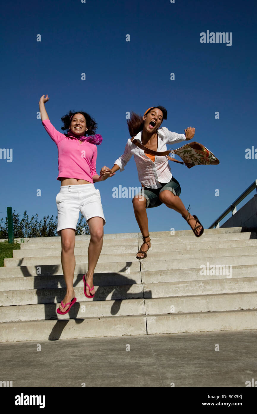 Two young women leaping in excitement Stock Photo - Alamy