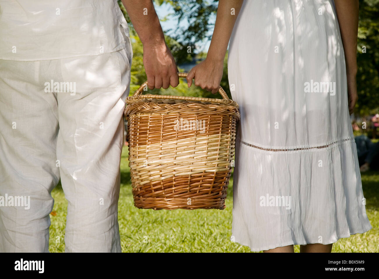 A young couple holding a basket together Stock Photo - Alamy