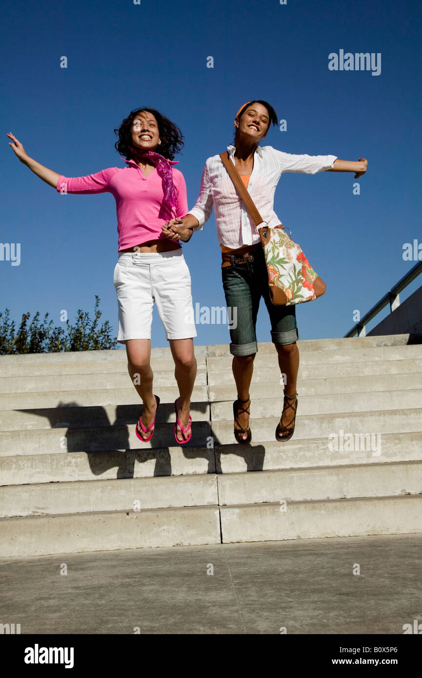 Two young women leaping in excitement Stock Photo - Alamy