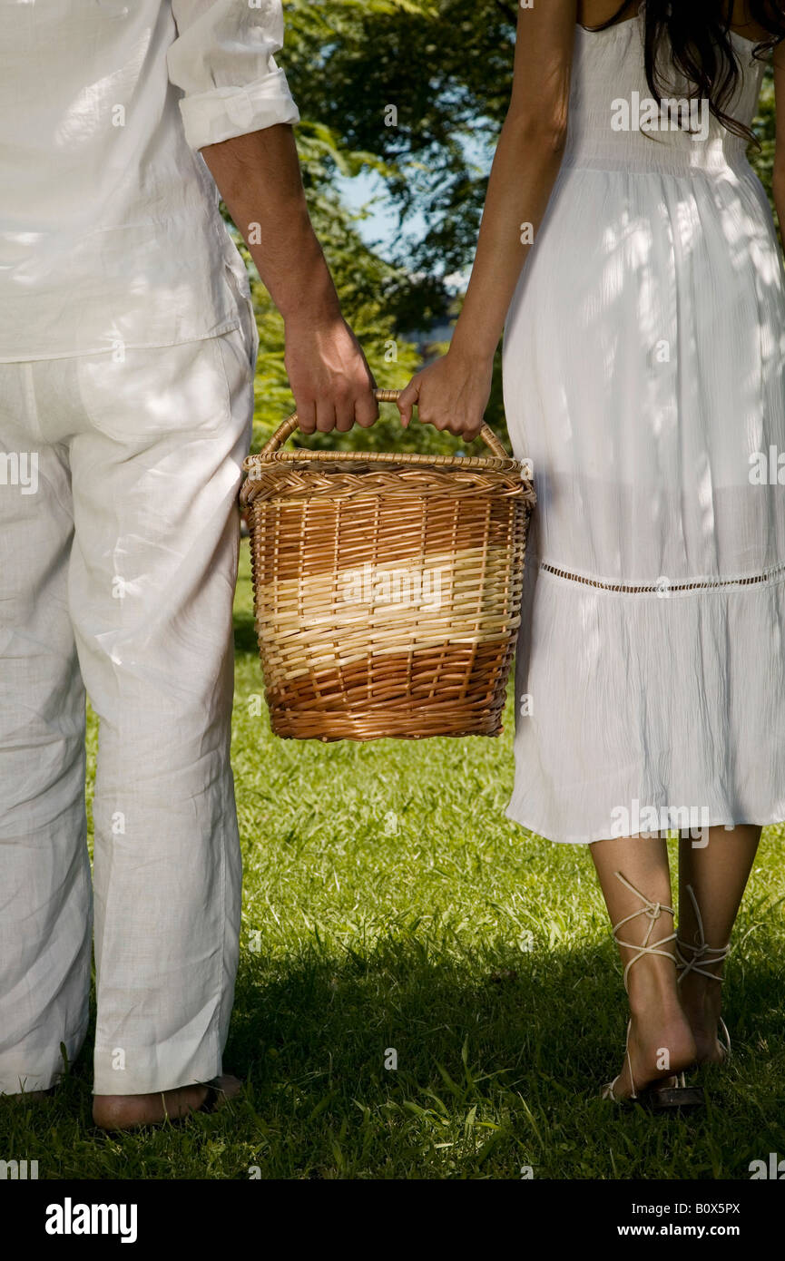 A young couple holding a basket together Stock Photo - Alamy