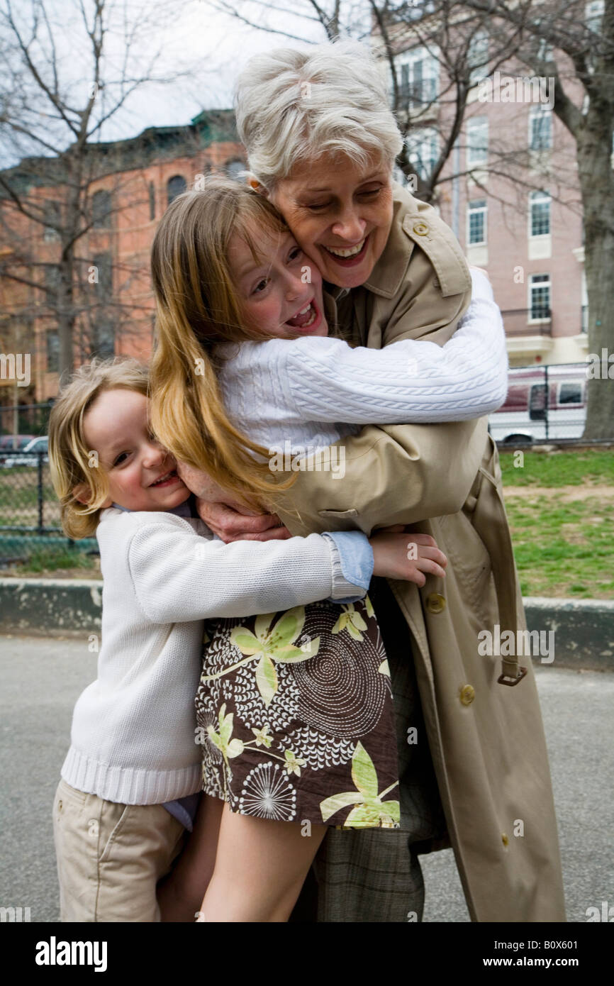 Grandchildren hugging their grandmother Stock Photo - Alamy