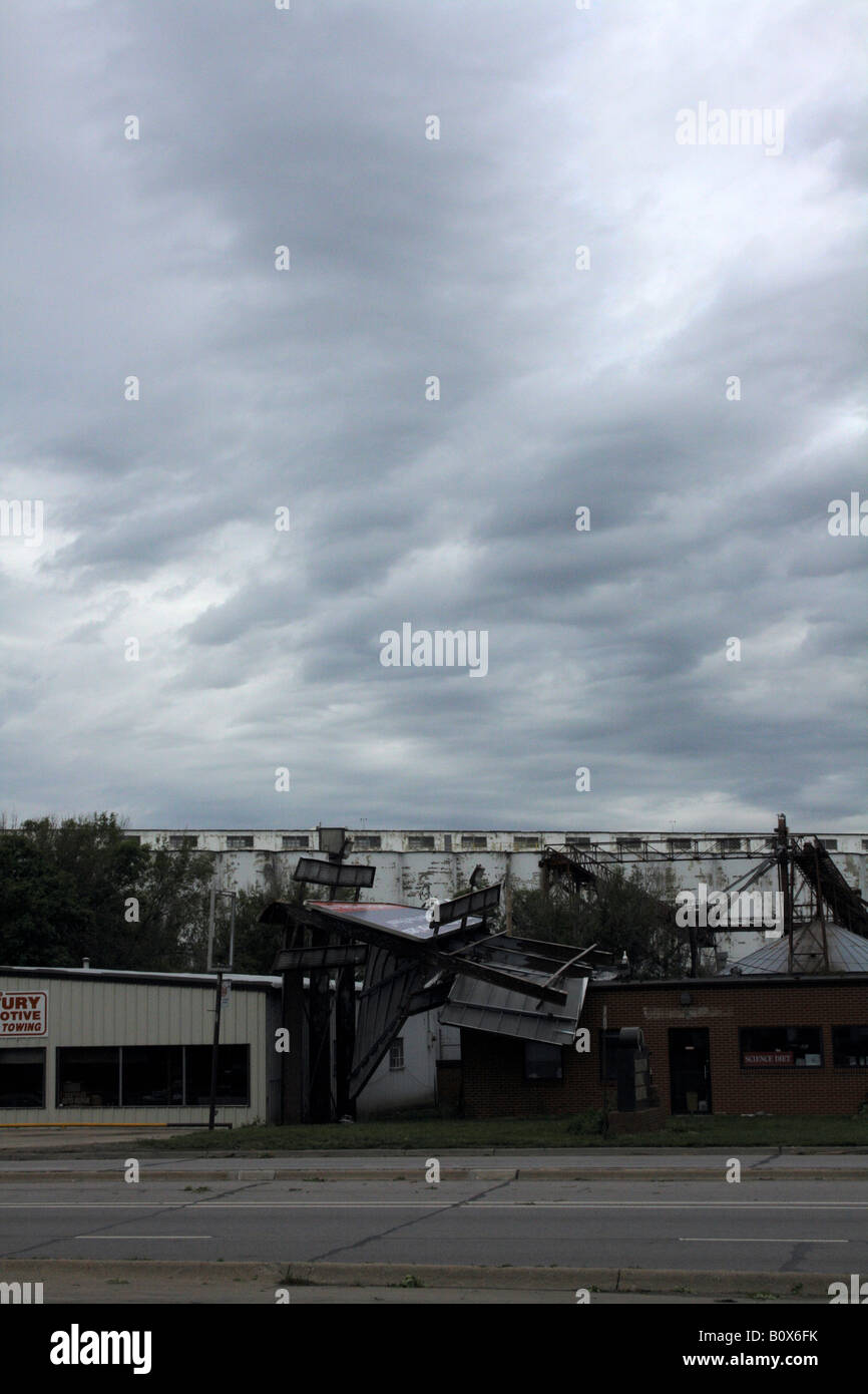 Toppled billboard after high wind storm event with storm clouds above ...