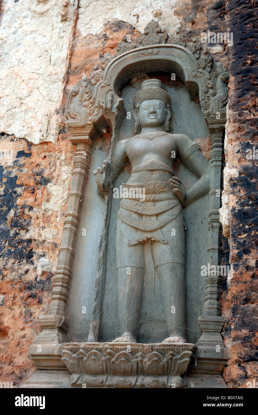 A Dvarapala statue in a niche of Preah Ko honouring ancestors Stock ...