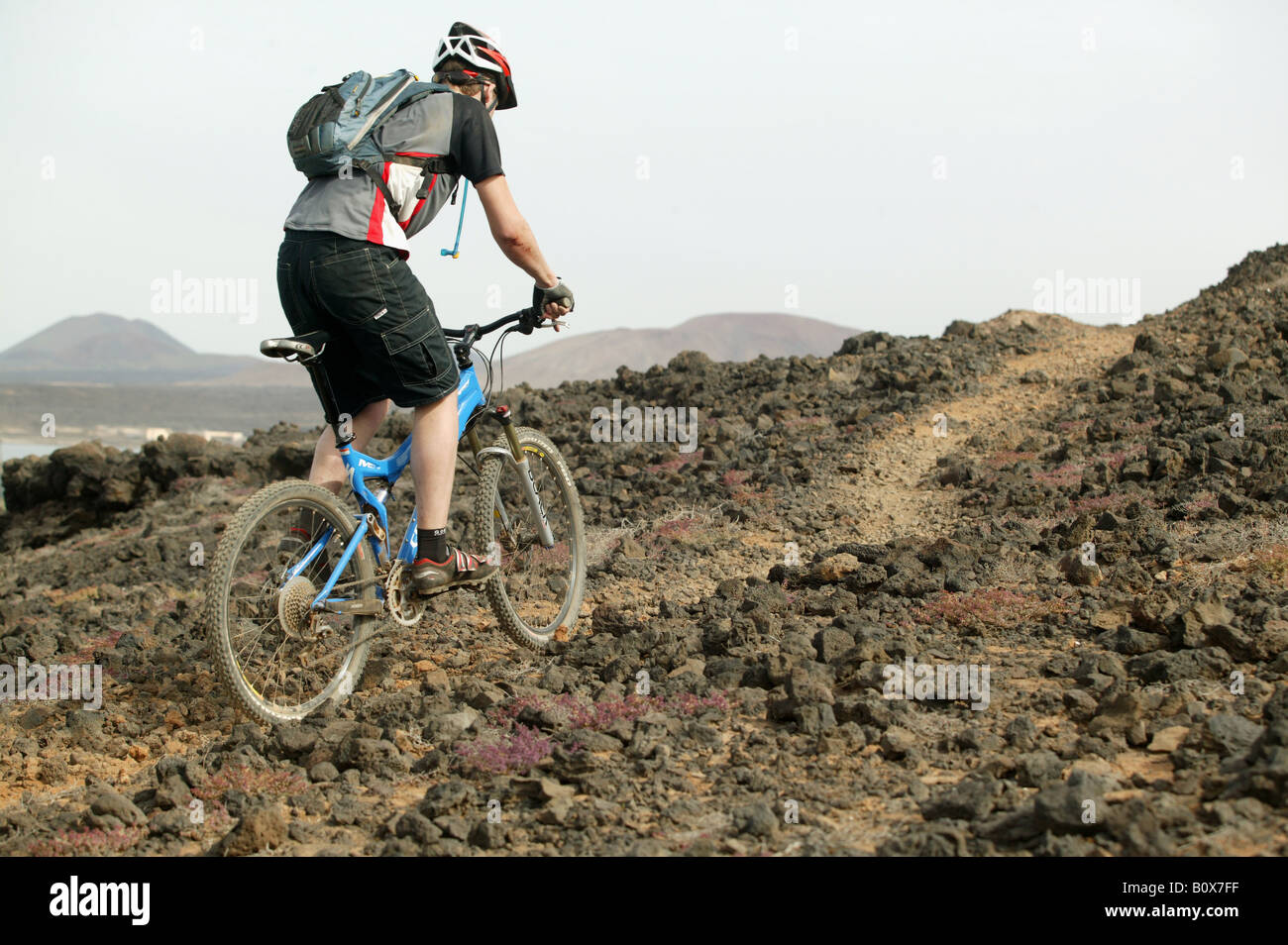Mountain Biker riding in a rocky landscape Stock Photo - Alamy