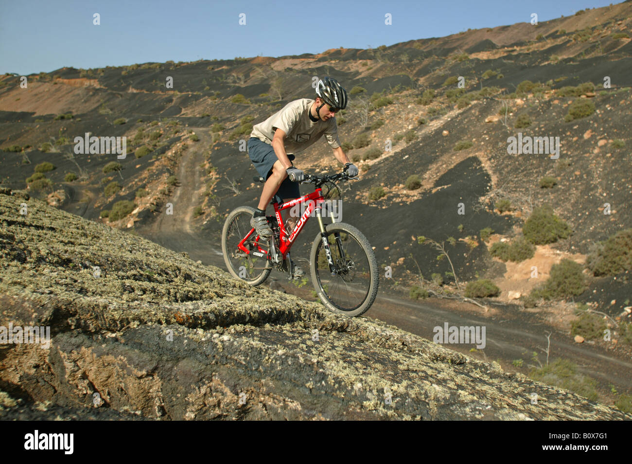 Mountain Biker riding in a rocky landscape Stock Photo - Alamy