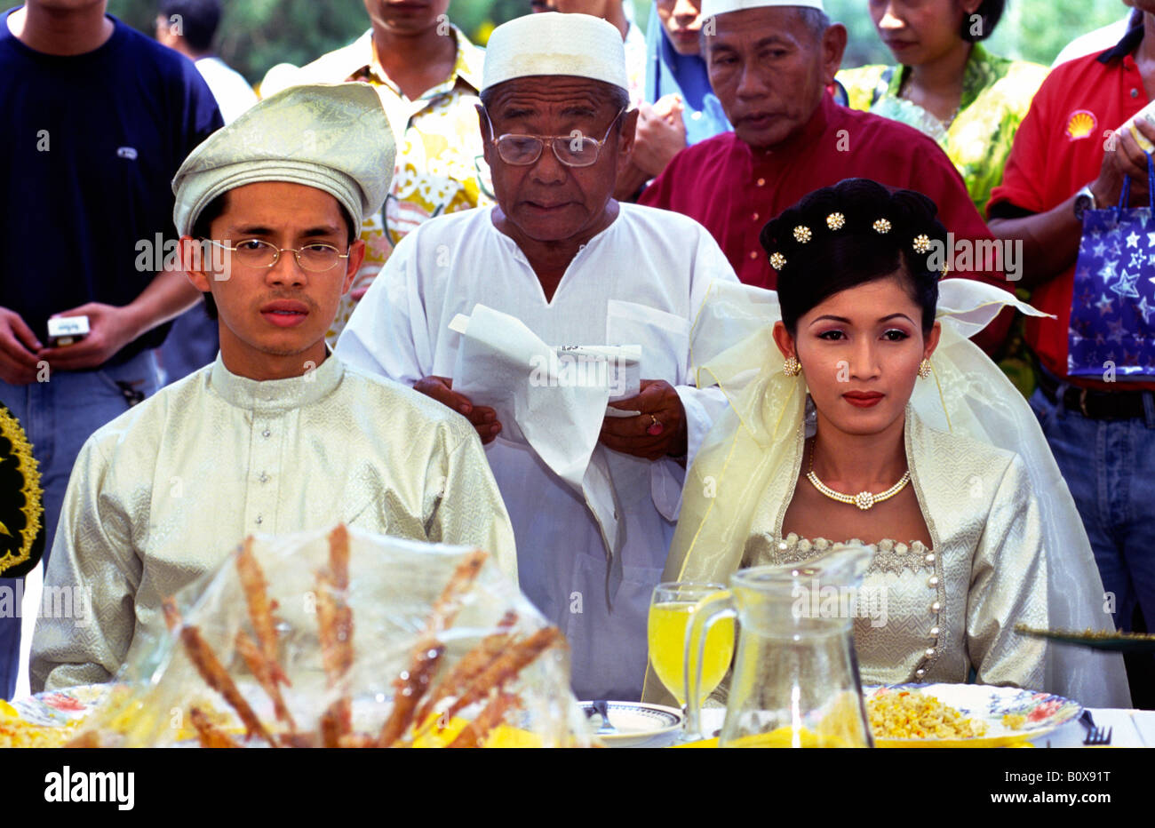 Malay couple during the "Akad Nikah" (marriage contract) ceremony wich ...