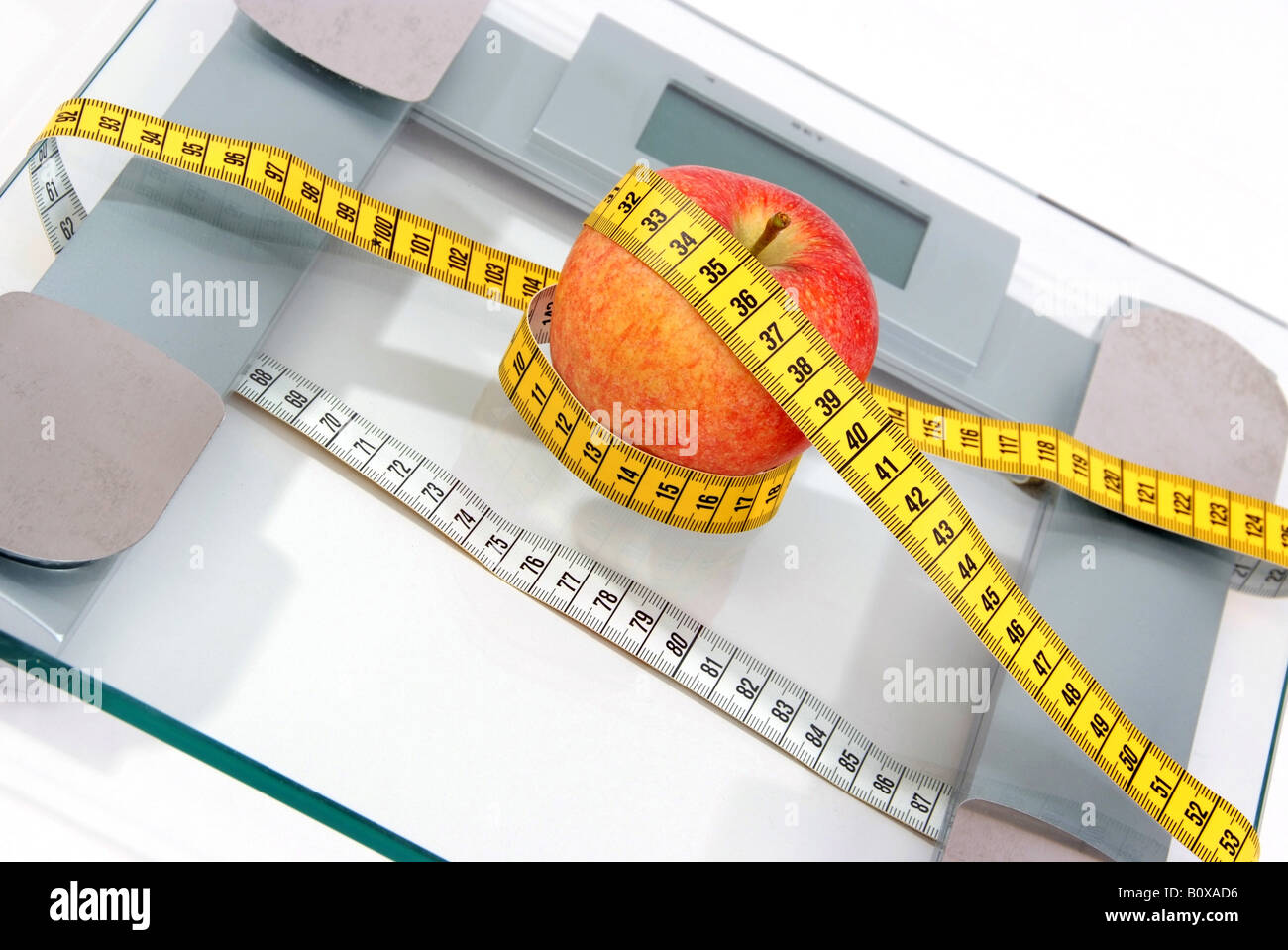 apple with tape measure on a scale Stock Photo - Alamy