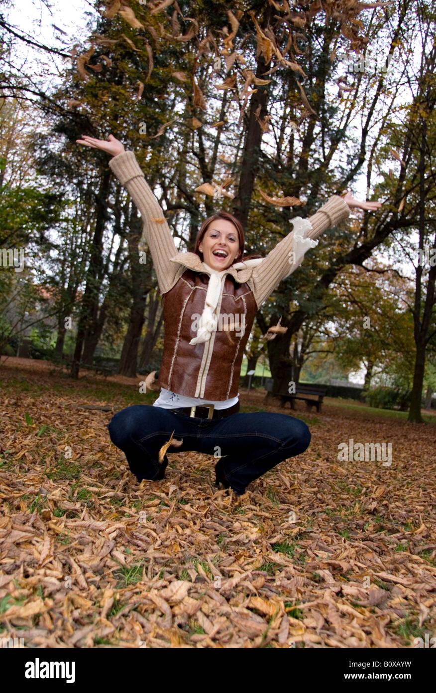 woman throwing with autumn foliage Stock Photo - Alamy