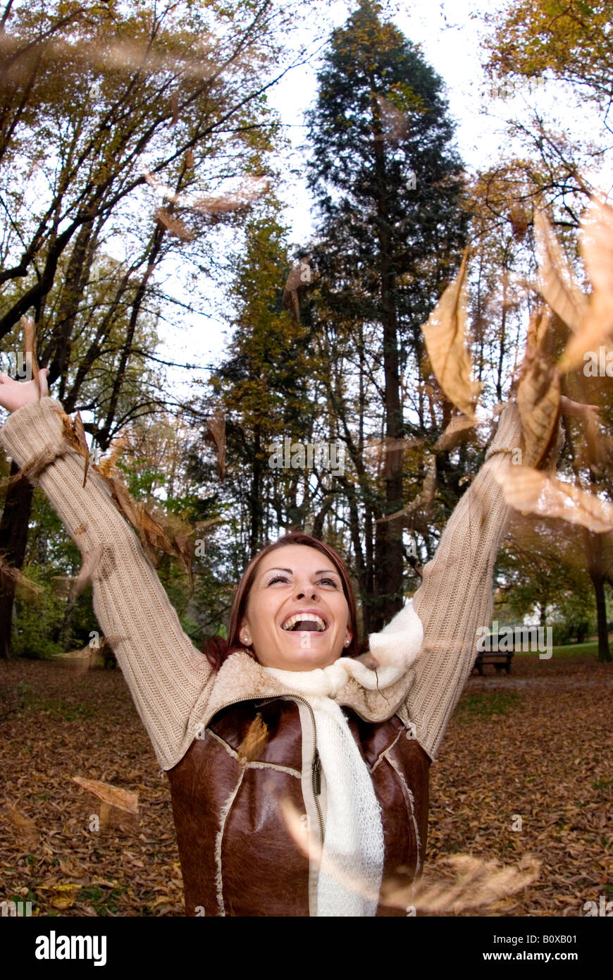 woman throwing with autumn foliage Stock Photo - Alamy