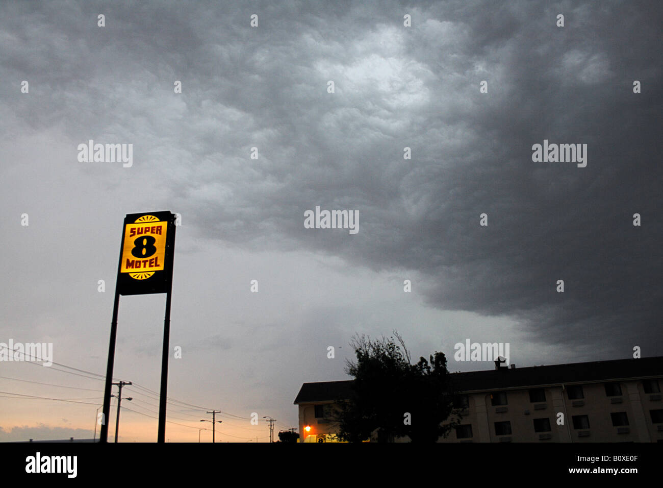 Super 8 motel sign and a thunderhead cloud behind Stock Photo - Alamy