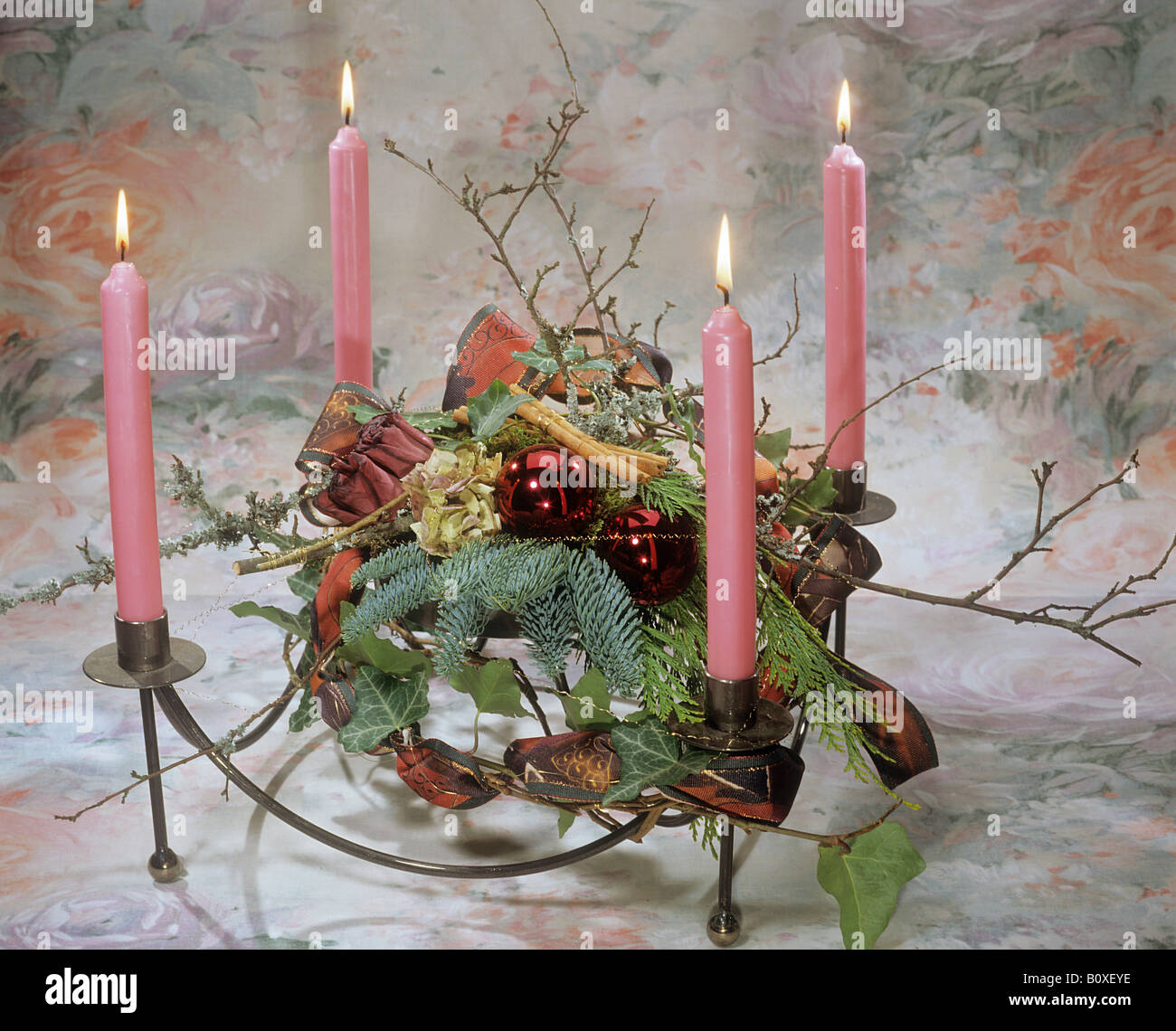 Advent wreath of twigs with four burning red candles and various ...