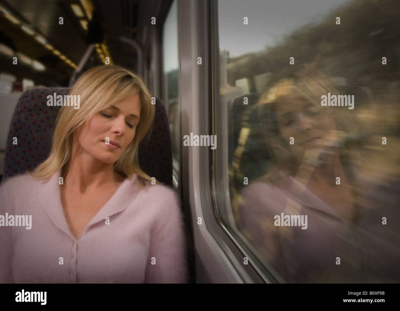 Girl asleep on train with reflection in window Stock Photo - Alamy
