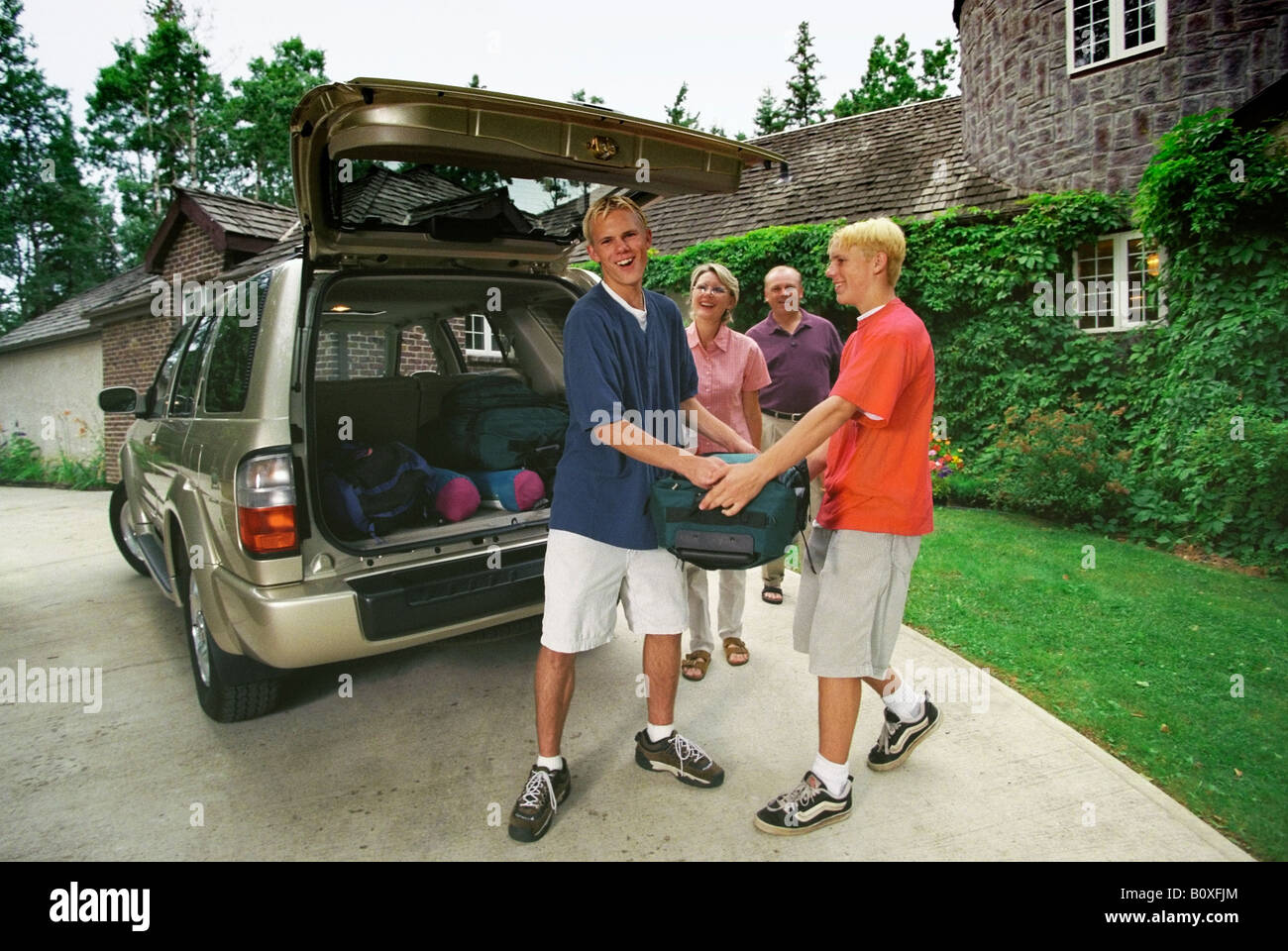 Family packing for camping trip Stock Photo - Alamy