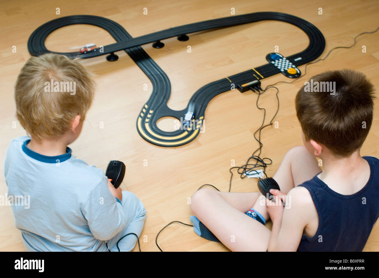 Boys Playing With Scalextric Racing Car Set Stock Photo - Alamy