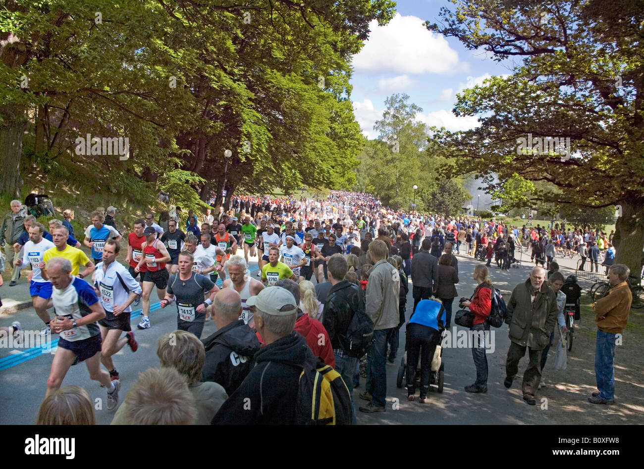 Crowds of people running in an athletic competition and audience lining ...