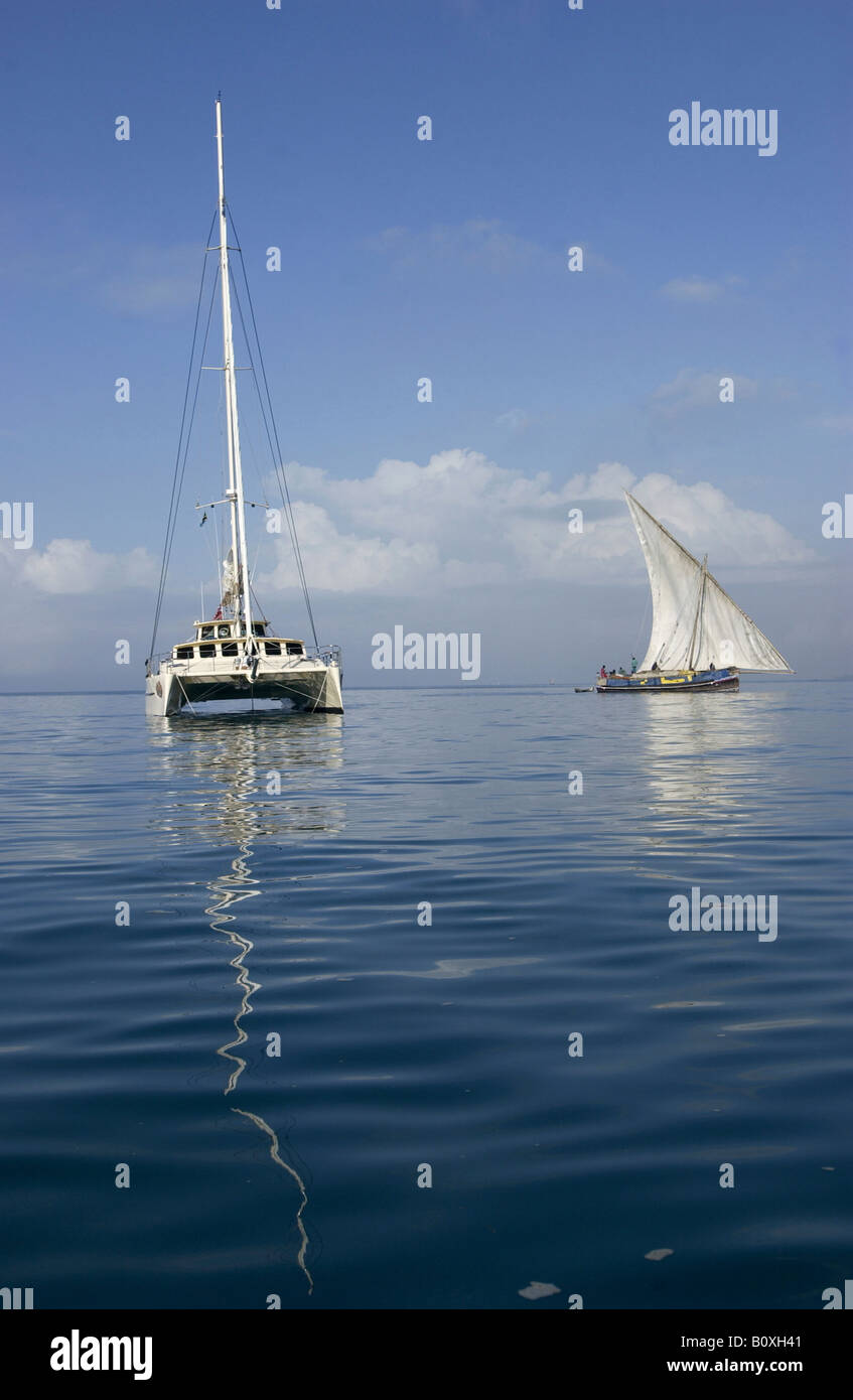 ancient dhow boat contrast modern yacht Stock Photo - Alamy