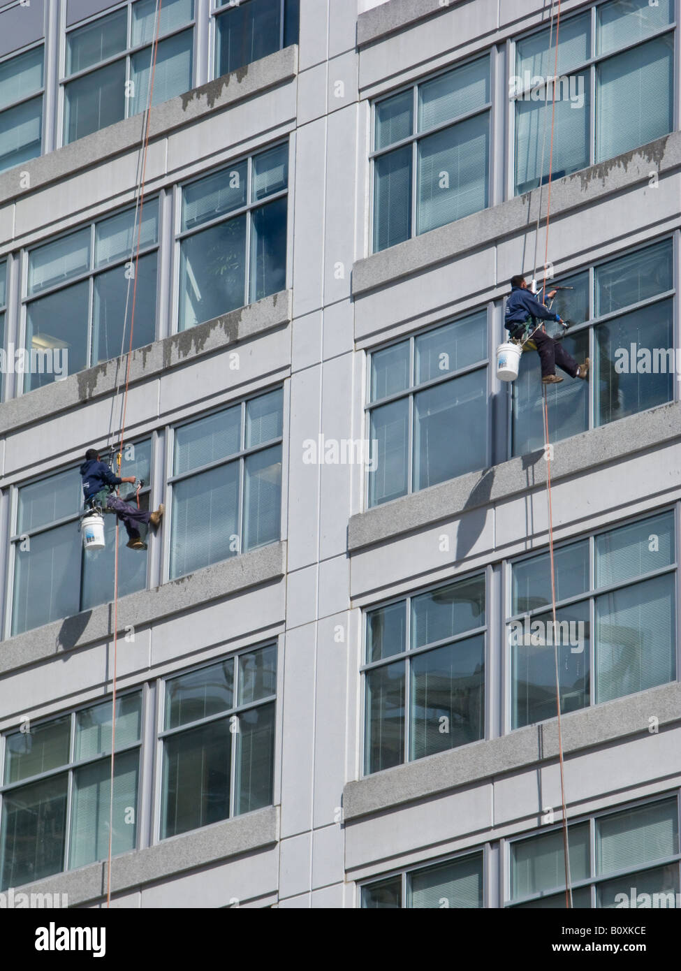 Worker washing windows on office building, Washington DC, USA Stock ...