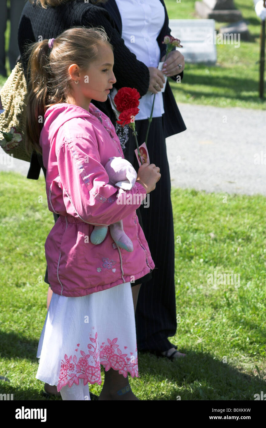 A young girl looks on during a funeral service Stock Photo - Alamy