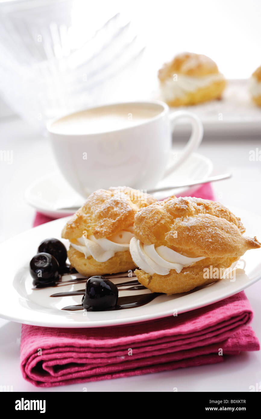 Cream puff on plate and cup of coffee Stock Photo - Alamy