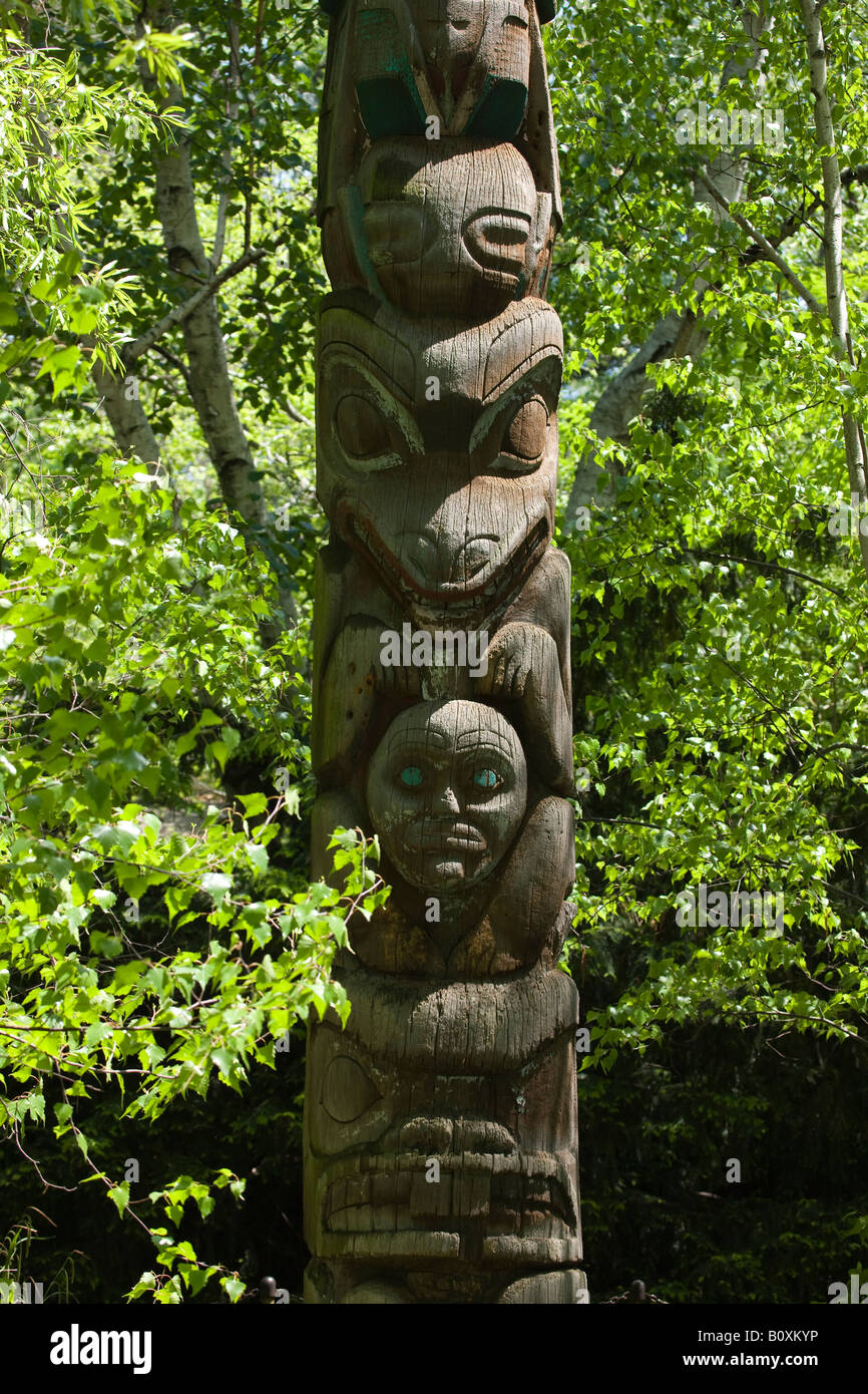 Symbolic faces carved on a totem pole Stock Photo - Alamy
