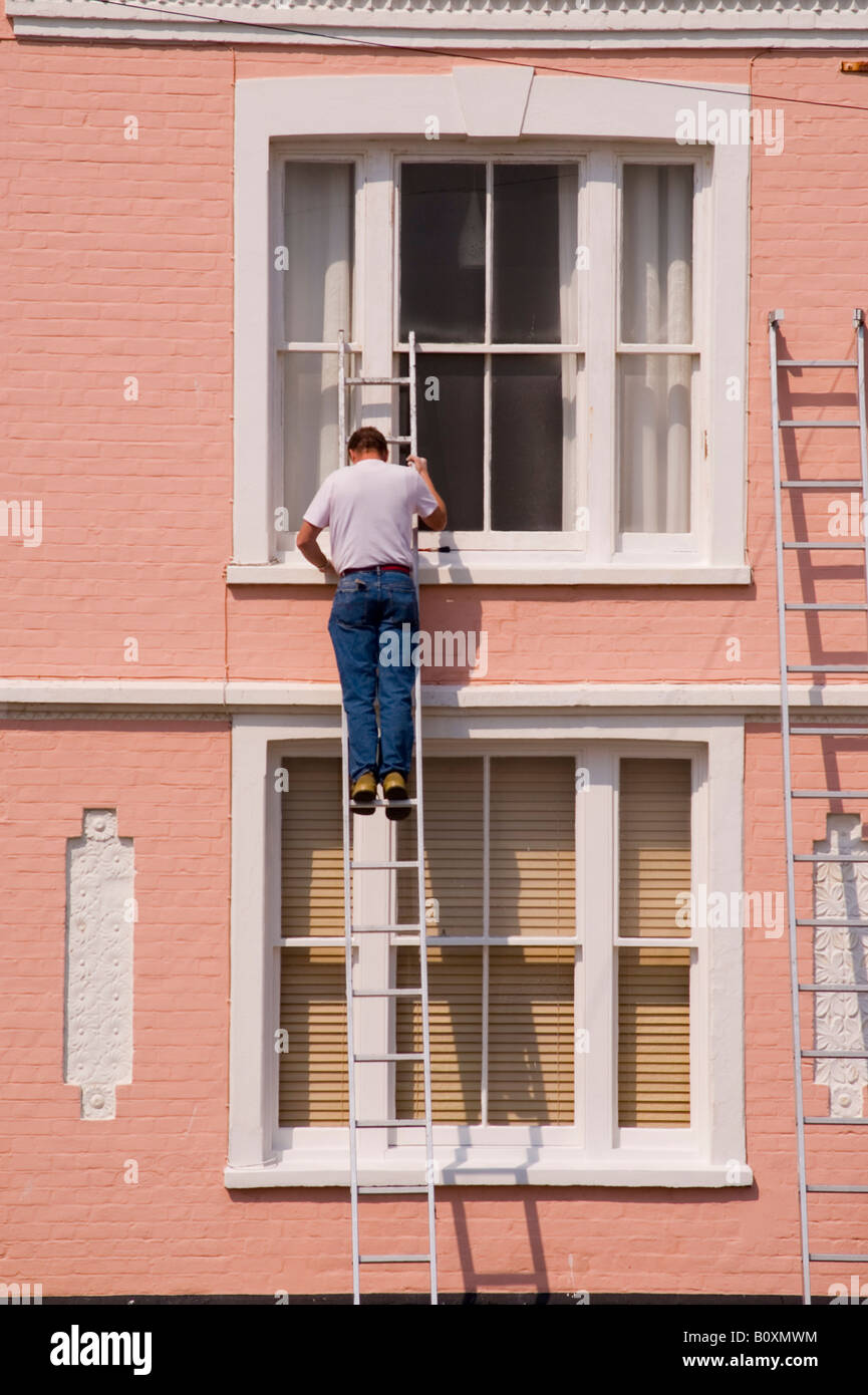 Man Painting Window On House Up Ladder Stock Photo - Alamy