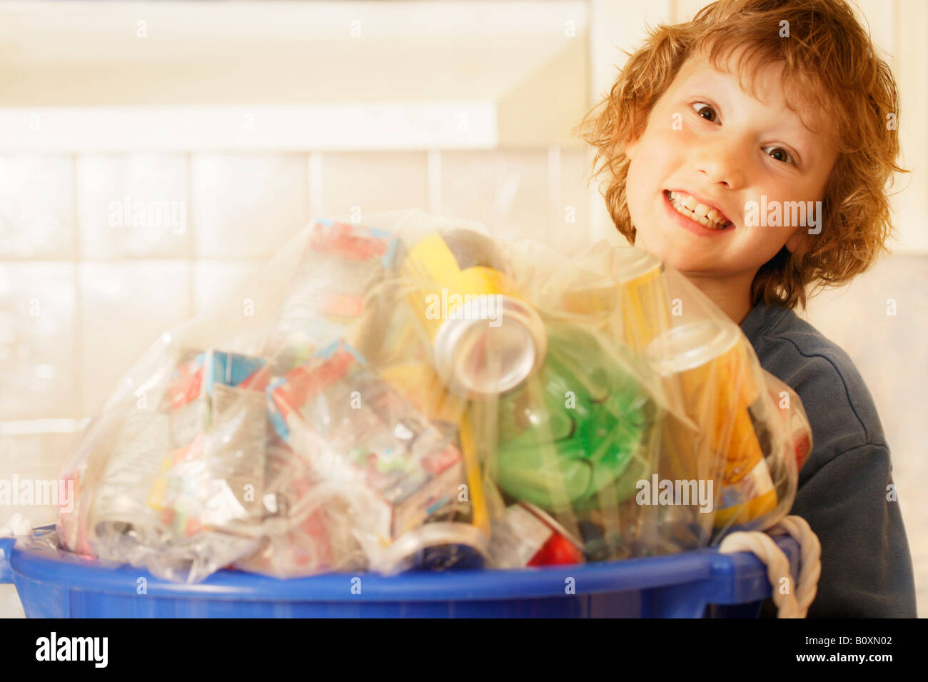 Boy holding bottles to be recycled Stock Photo - Alamy