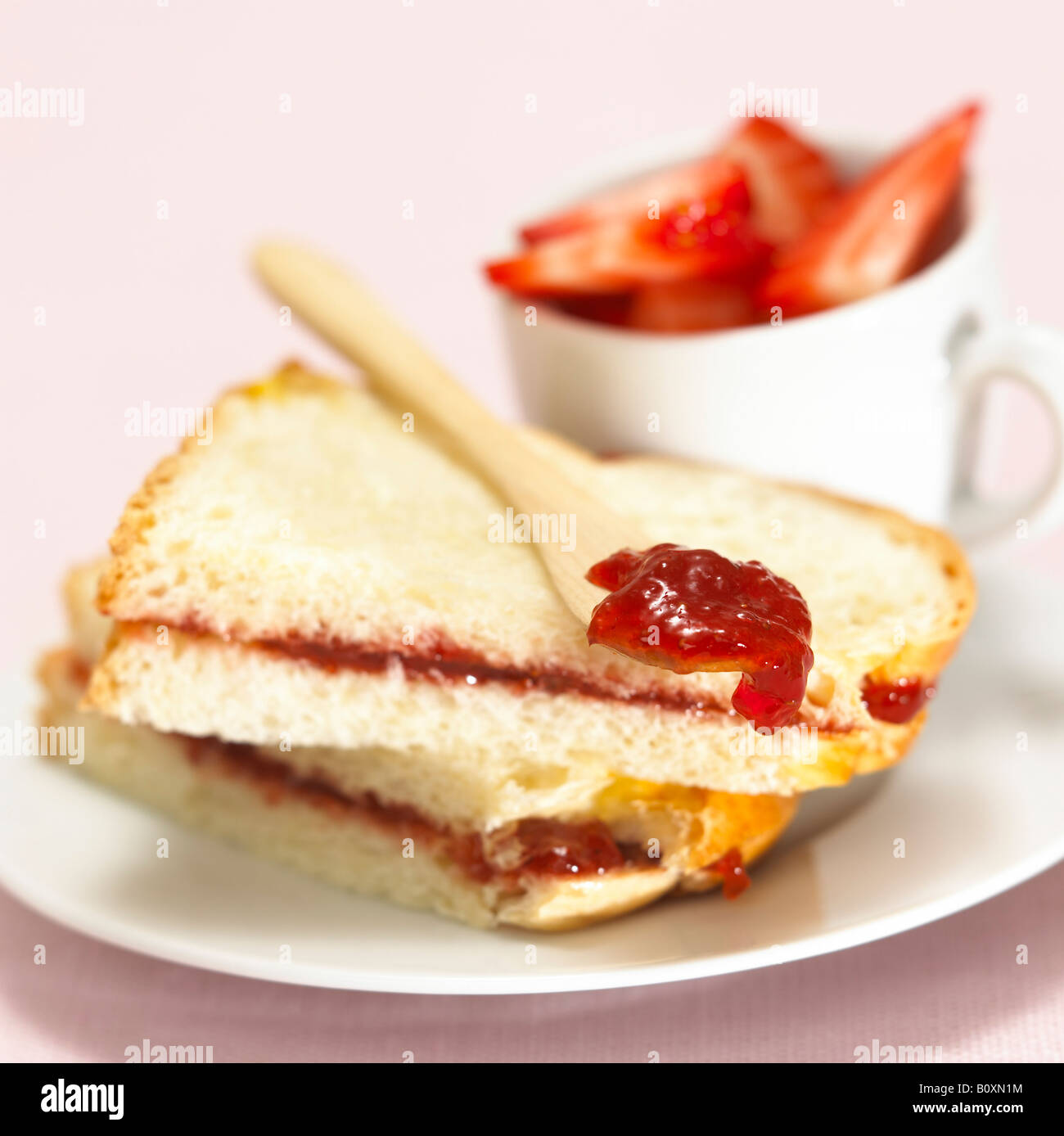 Toast with strawberry jam Stock Photo - Alamy