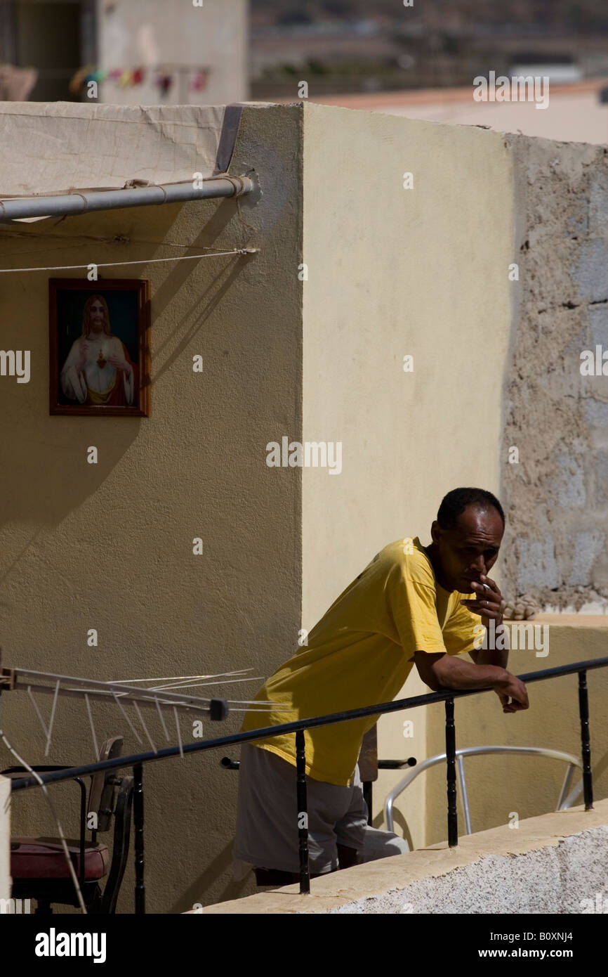 Man smoking a cigarette on his balcony in Espargos on the island of Sal ...