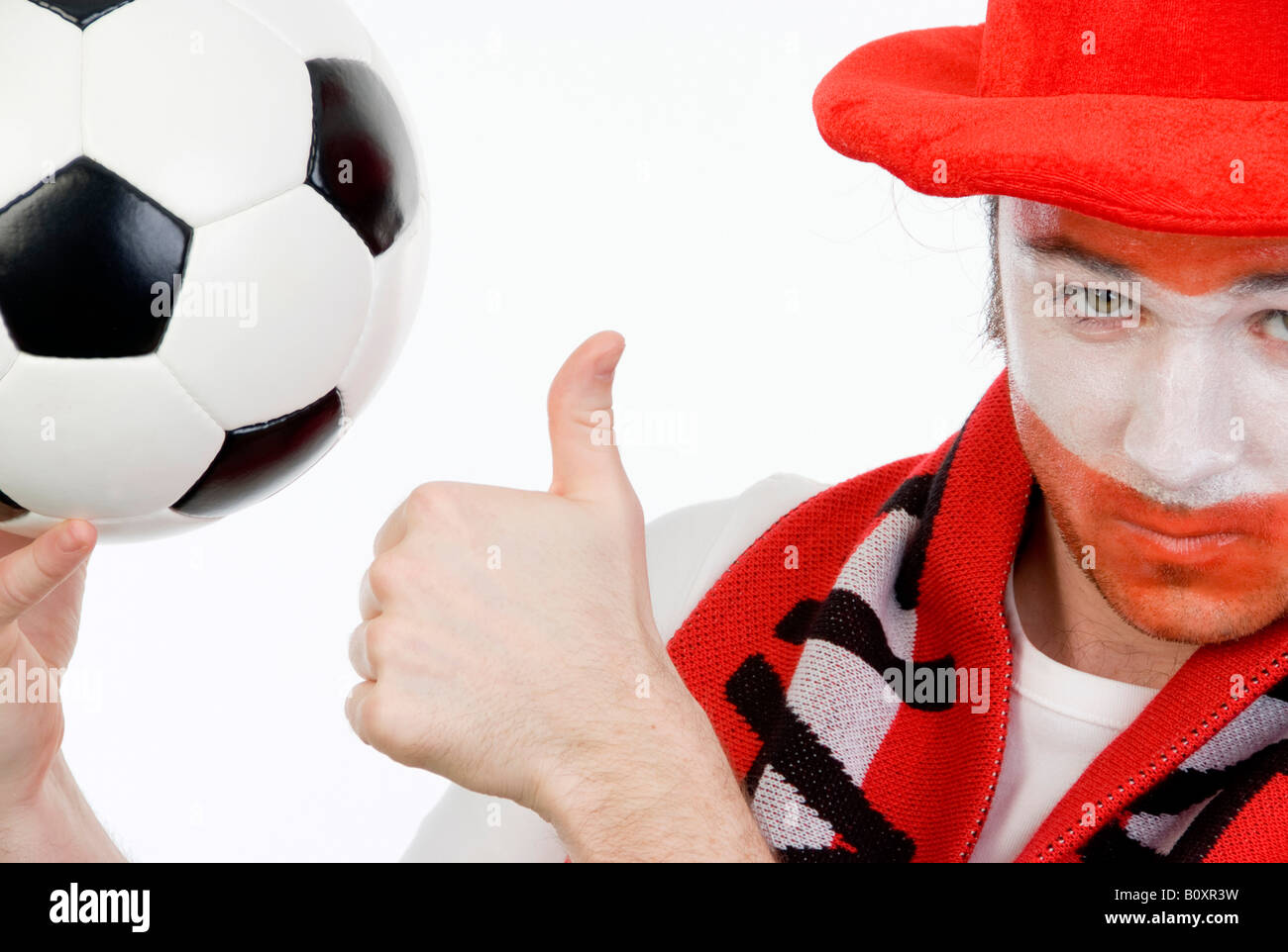 Austrian soccer fan with football, making thumb up Stock Photo - Alamy
