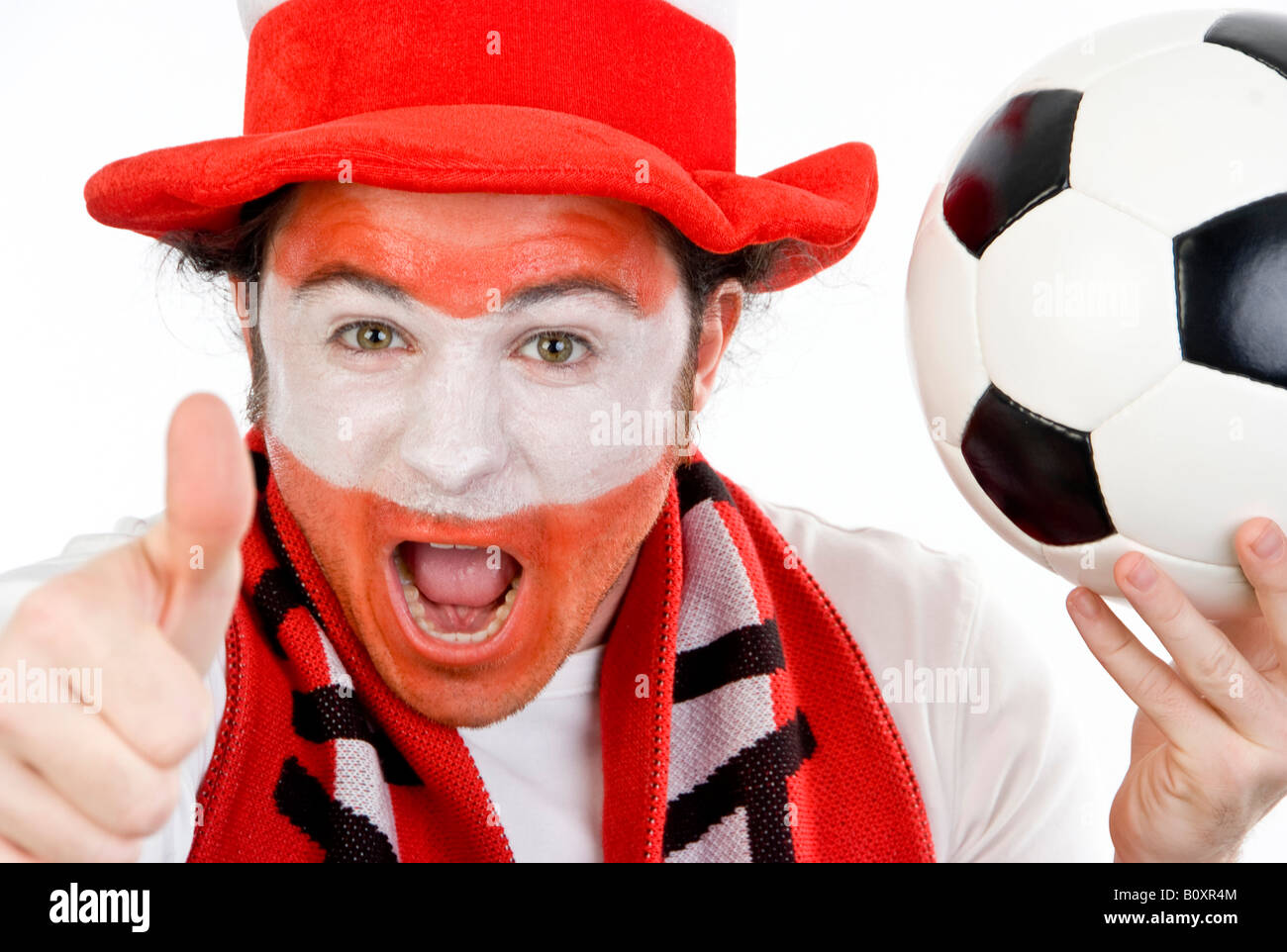 Austrian soccer fan with football, making thumb up Stock Photo - Alamy