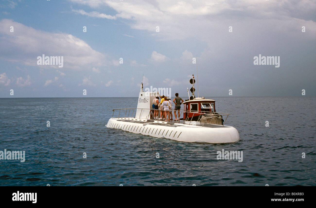 Passengers board the miniature sub Atlantis getting ready for a dive ...