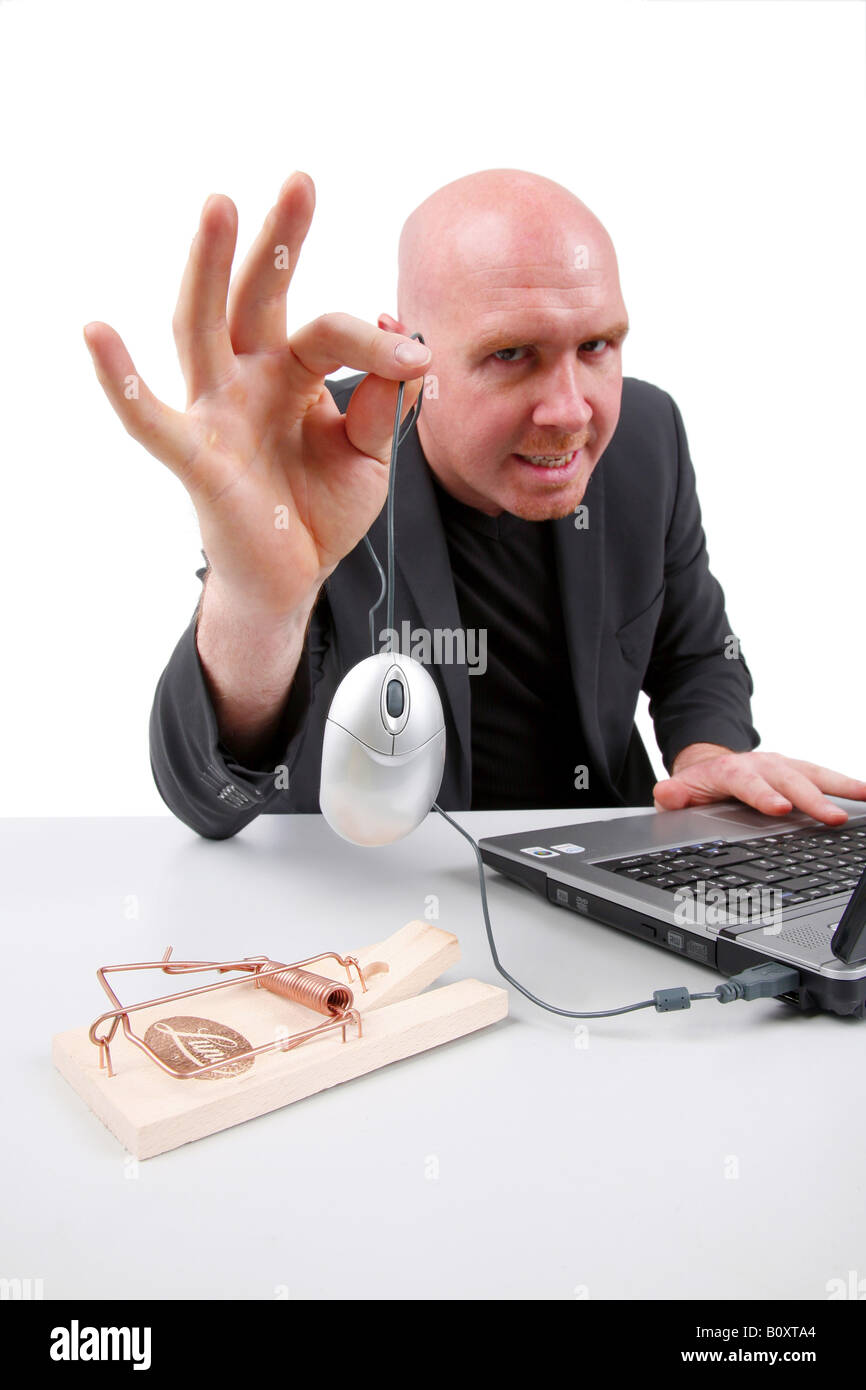 young bald headed man working at his writing desk is holding a computer ...