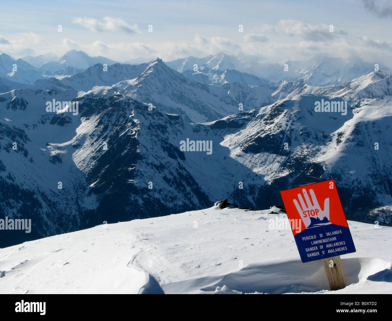 Sign in snowy mountain scenery of a skiing area warning against danger ...