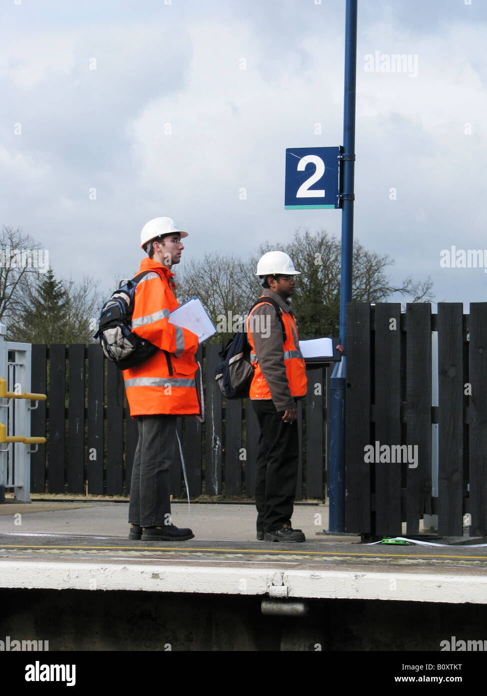 Employees of a train company wearing a helmet and a warning waistcoat ...
