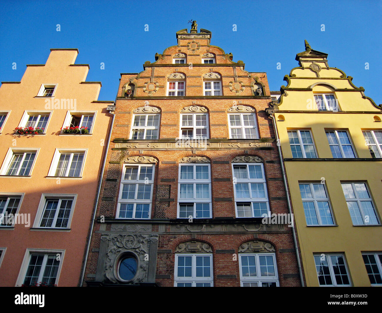 old house between two new houses in the same architecture, Poland ...