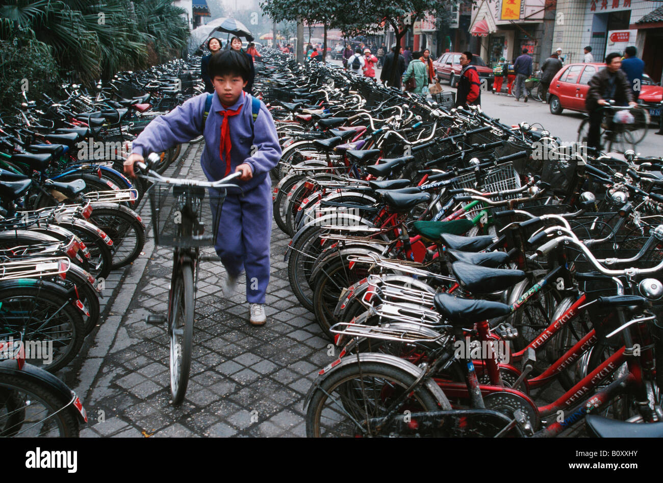 Boy with bike between parked bikes hi-res stock photography and images ...